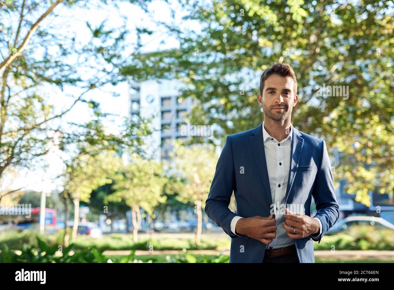 Stylish young businessman standing alone outside in the city Stock ...