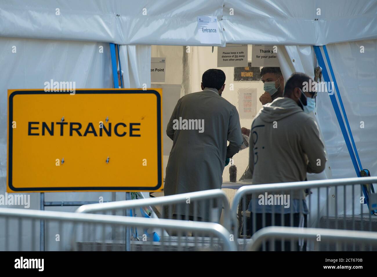 People queue at a Coronavirus testing facility in Sparkbrook ...