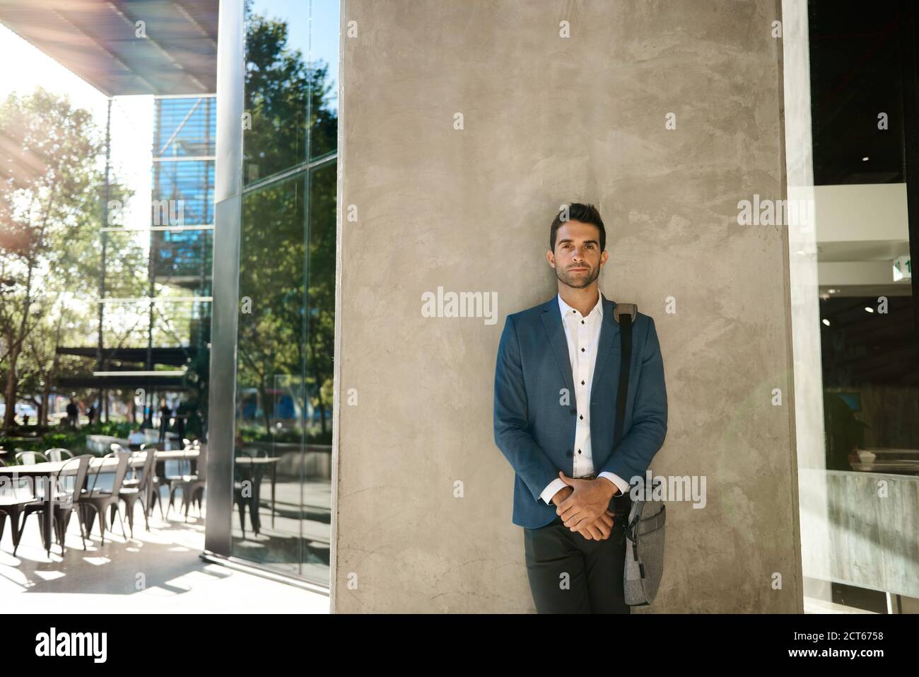 Businessman leaning against office wall hi-res stock photography and ...