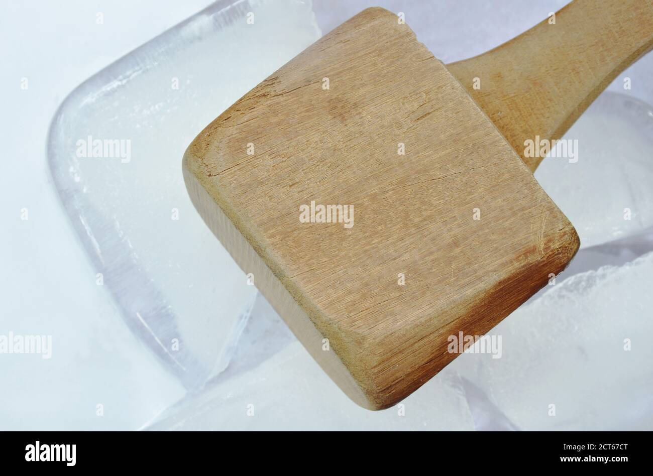 Big and heavy wooden hammer smashed ice brick on white background Stock ...