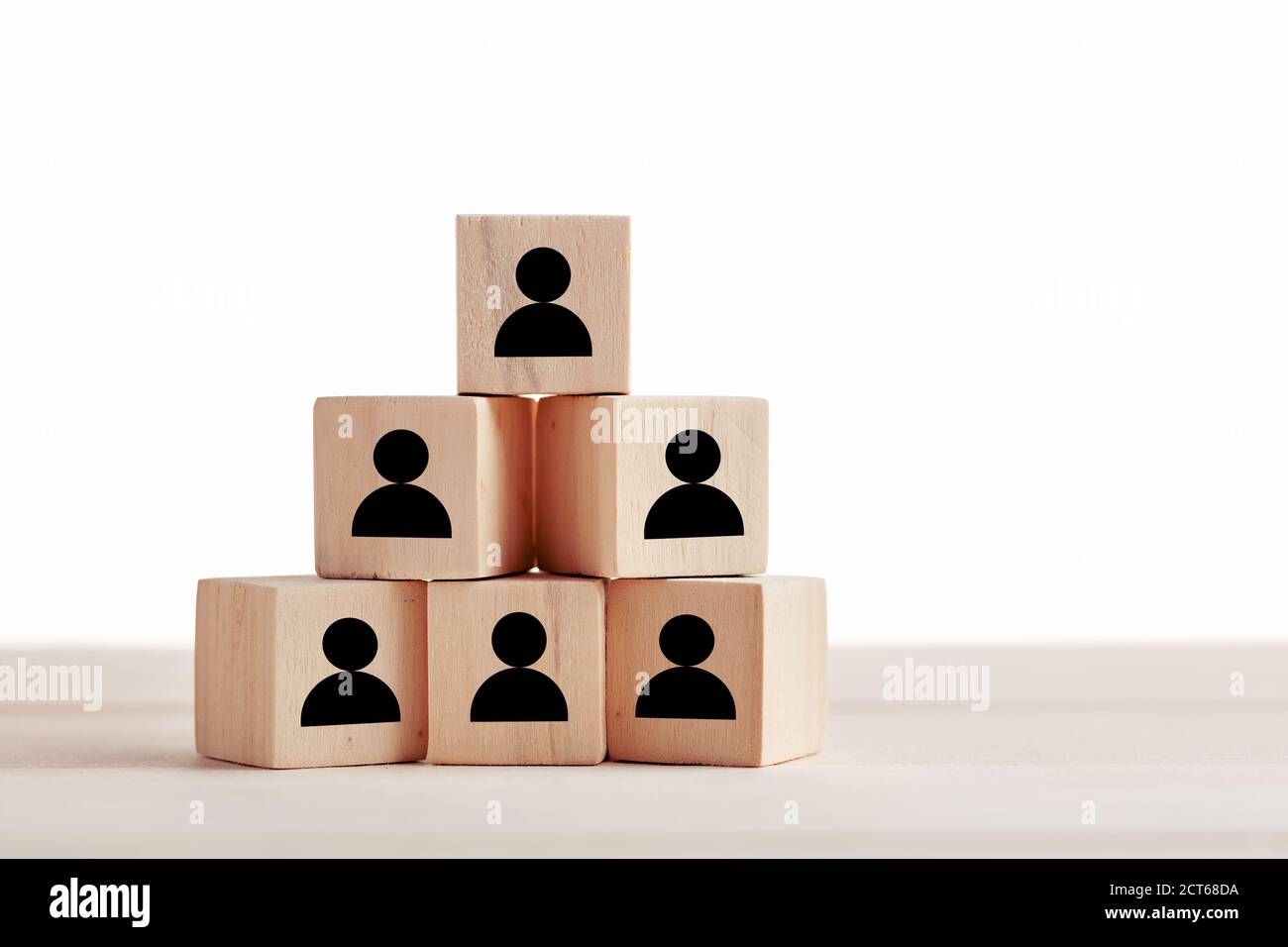 Wooden blocks with employee icon stacked as pyramid on white background ...