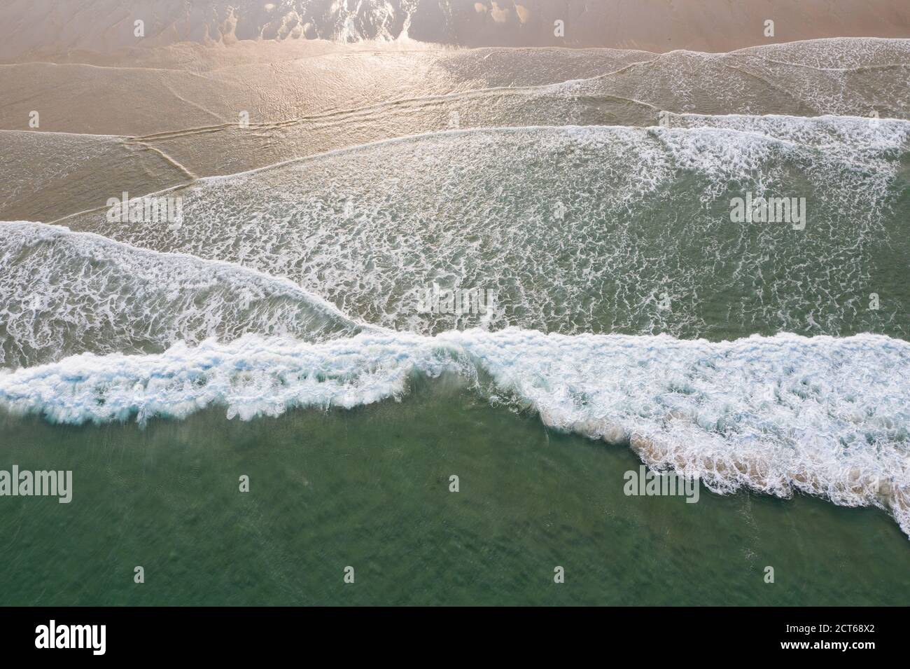The Atlantic Ocean washes onto a scenic, sandy beach on Cape Cod ...