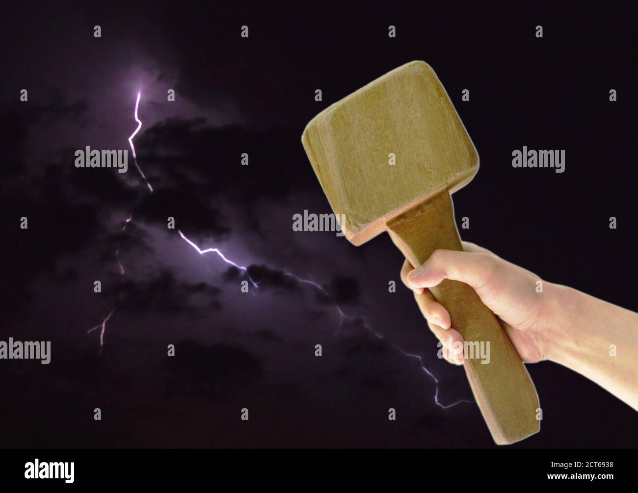 Hand holding big wooden hammer on thunderbolt in night background Stock ...