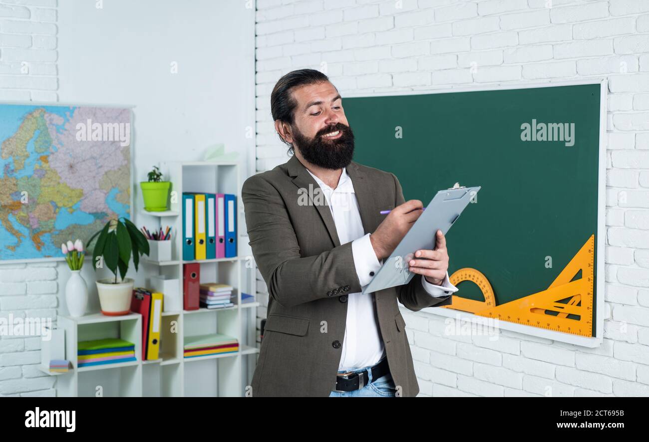 happy male lecturer with workbook and books ready for lesson, school ...
