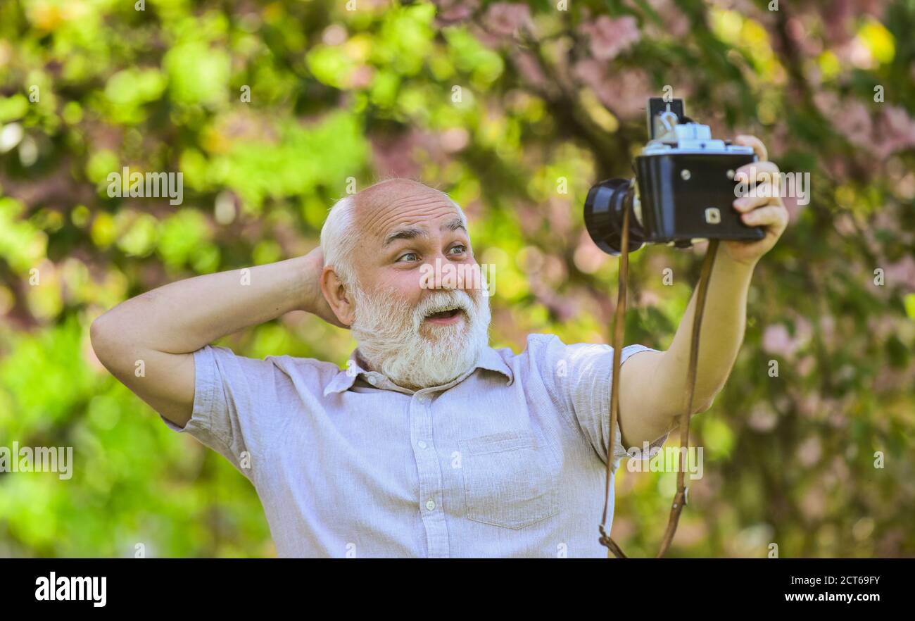 Everyone photogenic. Senior man taking selfie photo vintage camera ...