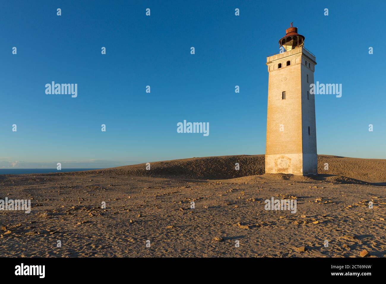 The defunct lighthouse at Rubjerg Knude, Denmark, in golden evening ...