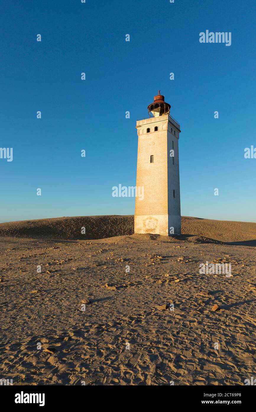 The defunct lighthouse at Rubjerg Knude, Denmark, in golden evening ...