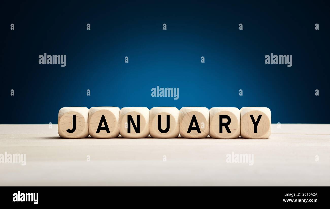 The month January written on wooden cubes with blue winter background ...