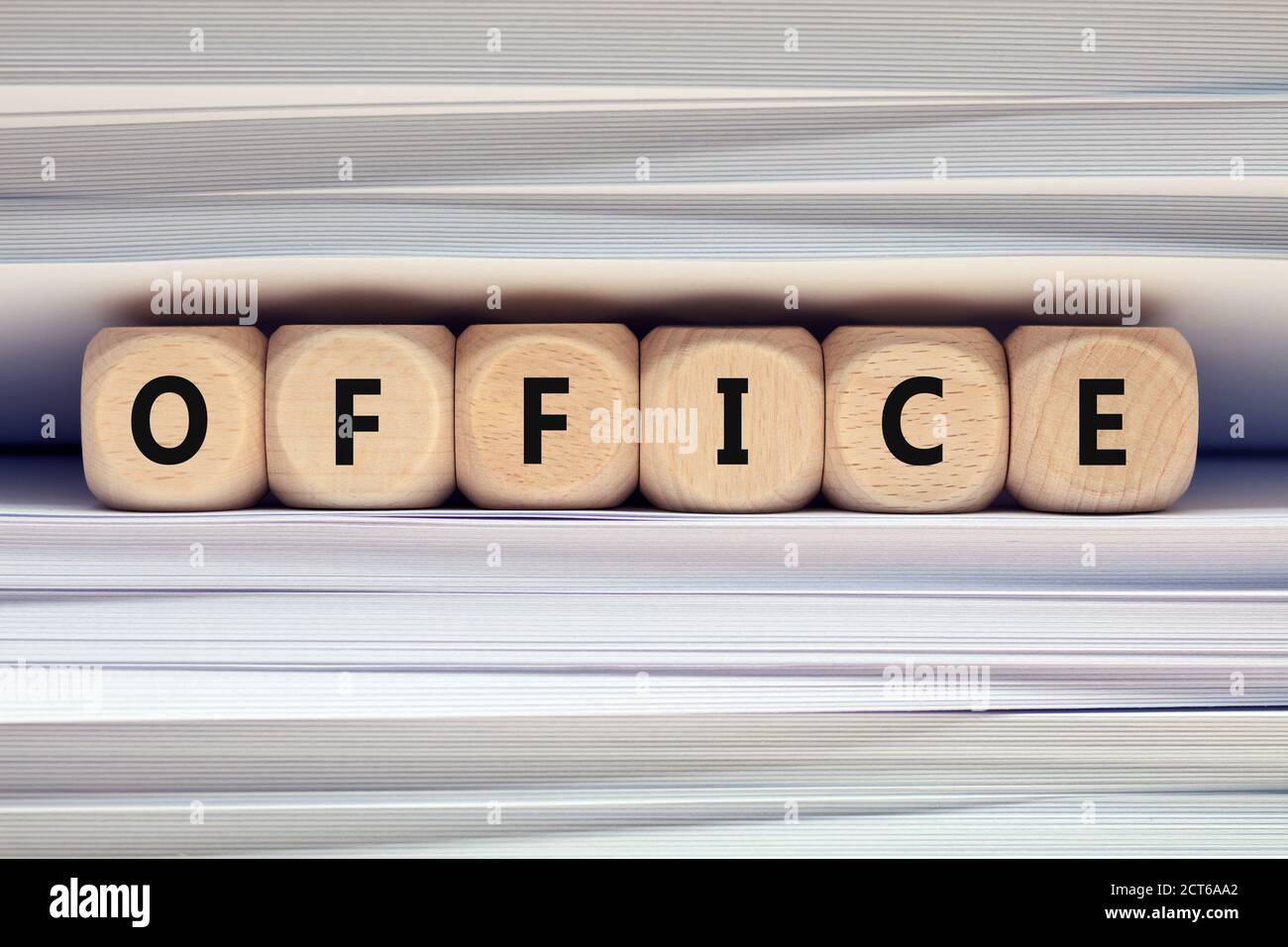 The word office on wooden cubes against pile of files and folders ...