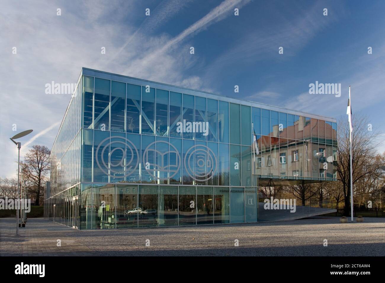 The exterior glass walls of a modern library building, internet icons ...