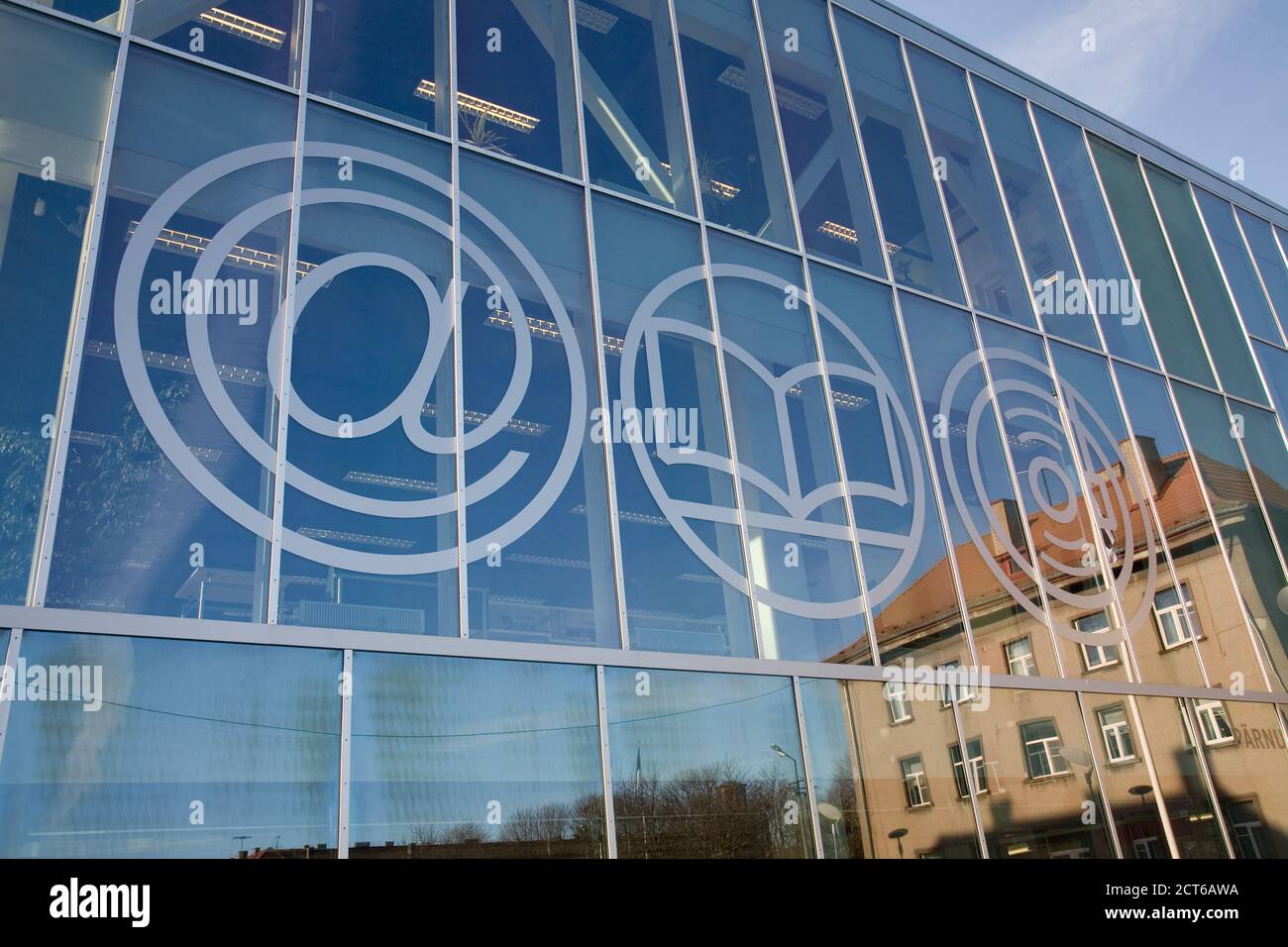 The exterior glass walls of a modern library building, internet icons ...