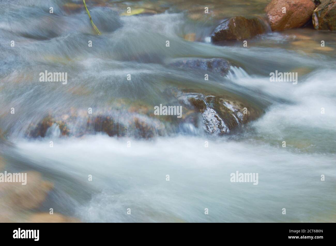 Blurry water flowing on the rock and wave splashing in river Stock ...