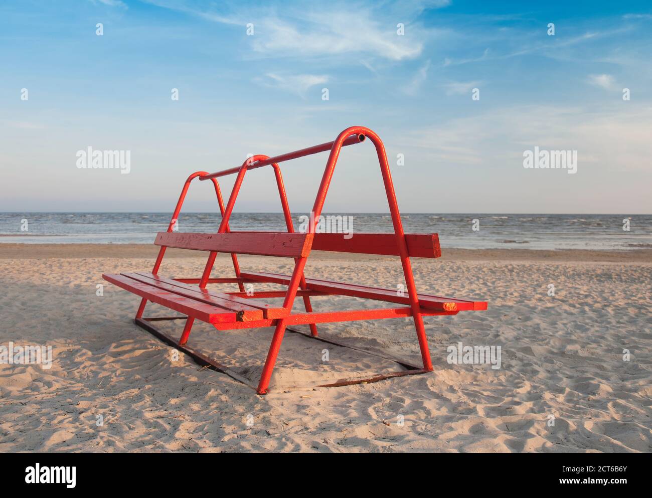 Red Park Bench on the Beach Stock Photo - Alamy