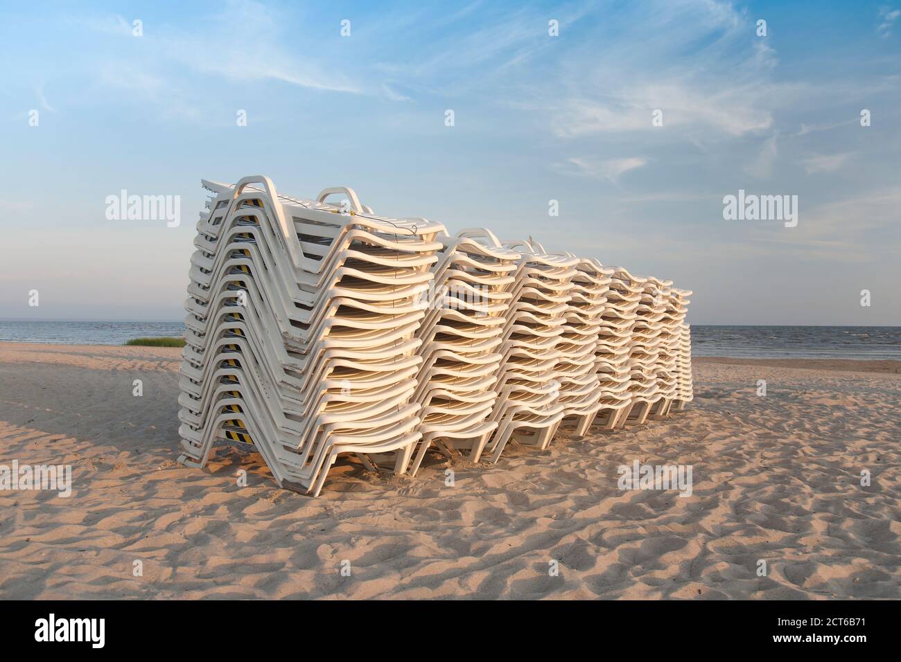 Stacked Lounge Chairs on a Beach Stock Photo - Alamy