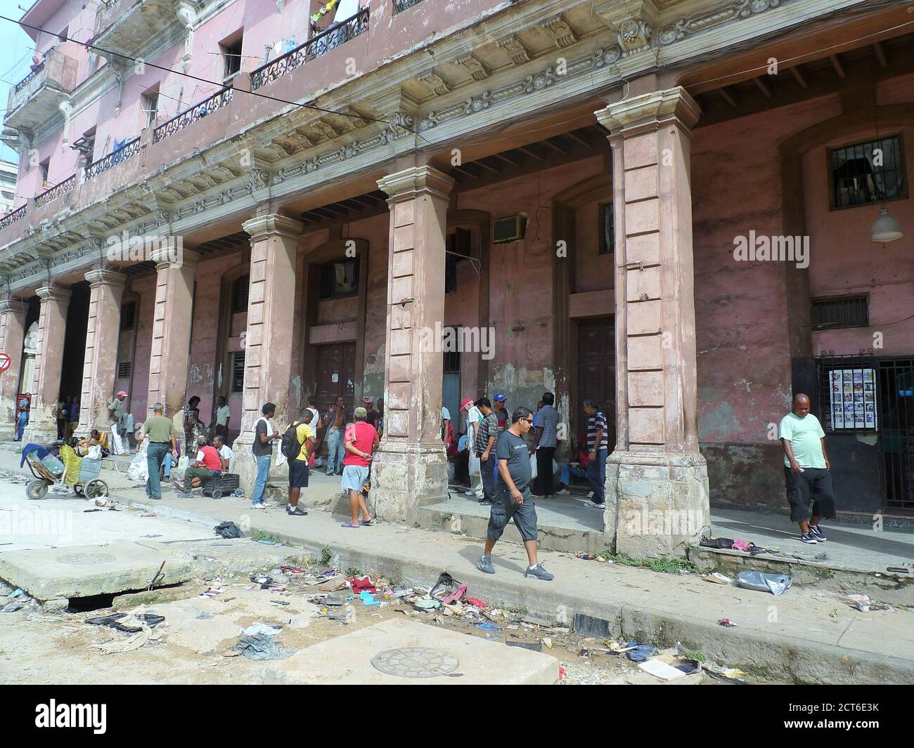 PEOPLE ON A ROUGH STREET WITH AN ABANDONED BUILDING Stock Photo - Alamy