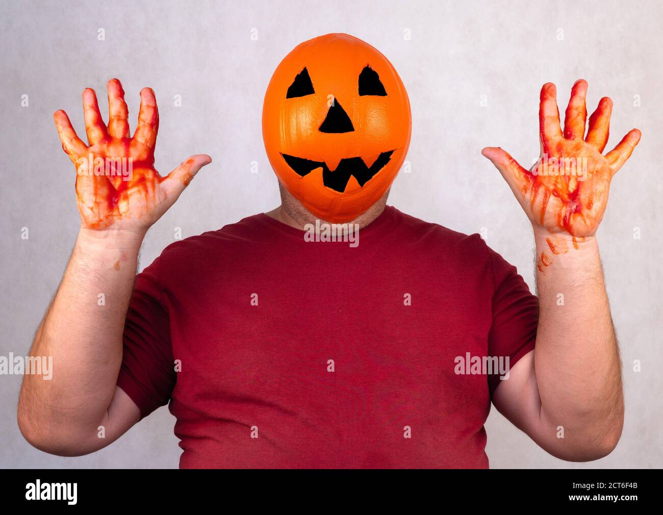 man in a Halloween mask on a white background. person with orange ...