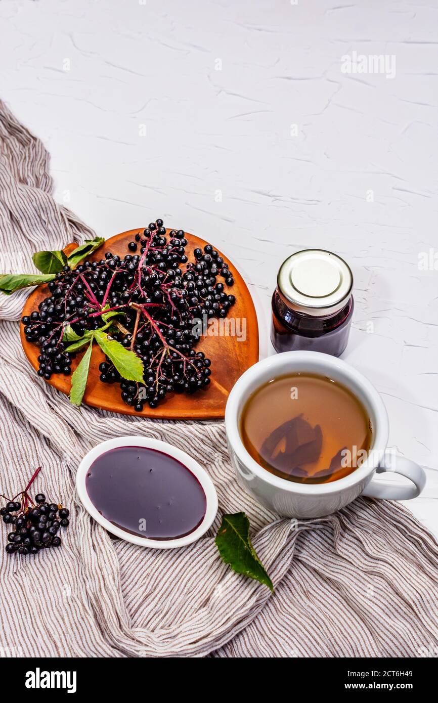 Elderberry jam, syrup, confiture and hot tea. Ripe berries, sweet and ...