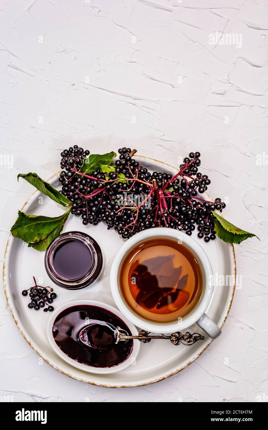 Elderberry jam, syrup, confiture and hot tea. Ripe berries, sweet and ...