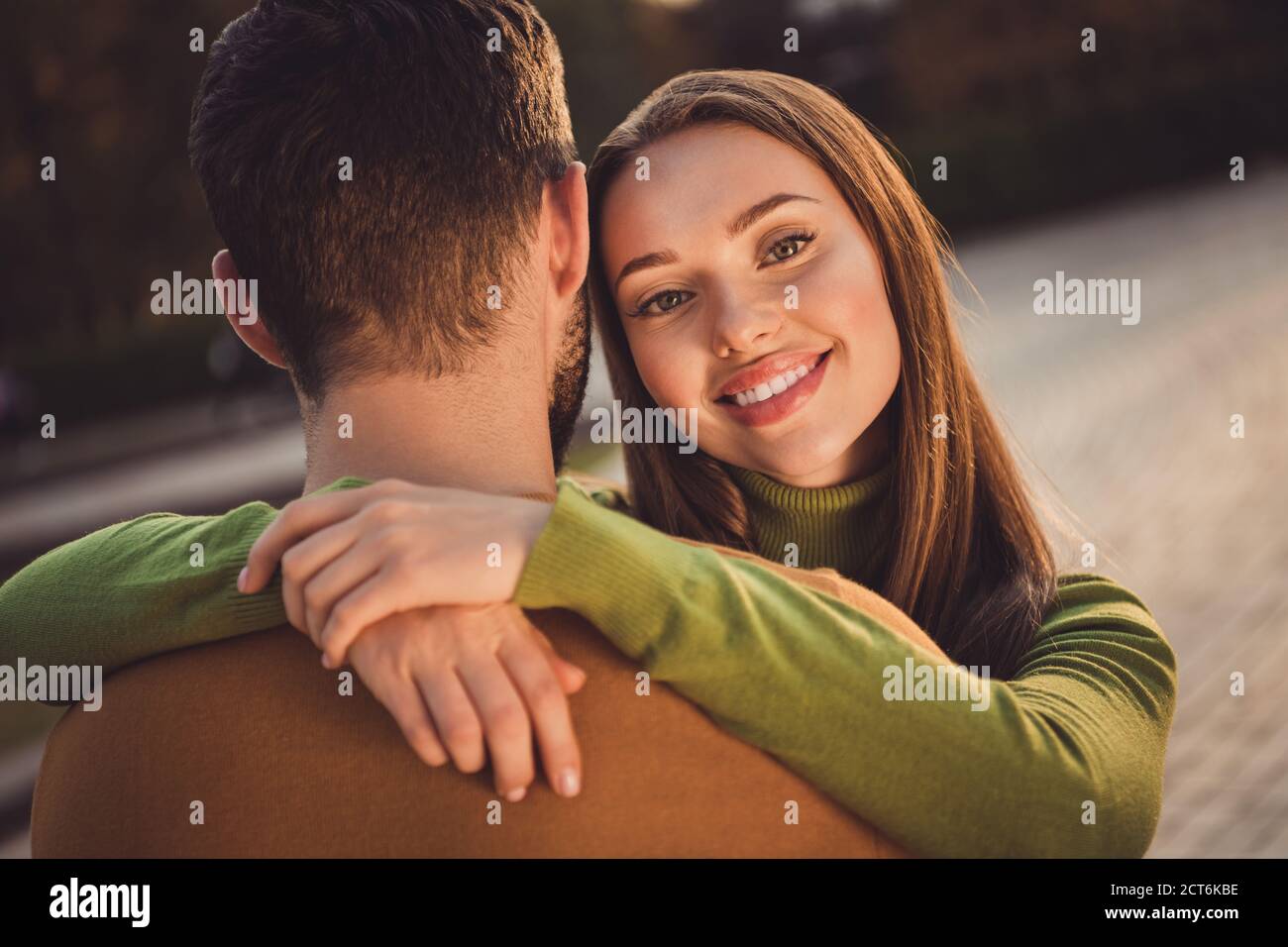 Back rear spine view portrait of charming positive girl hug her ...