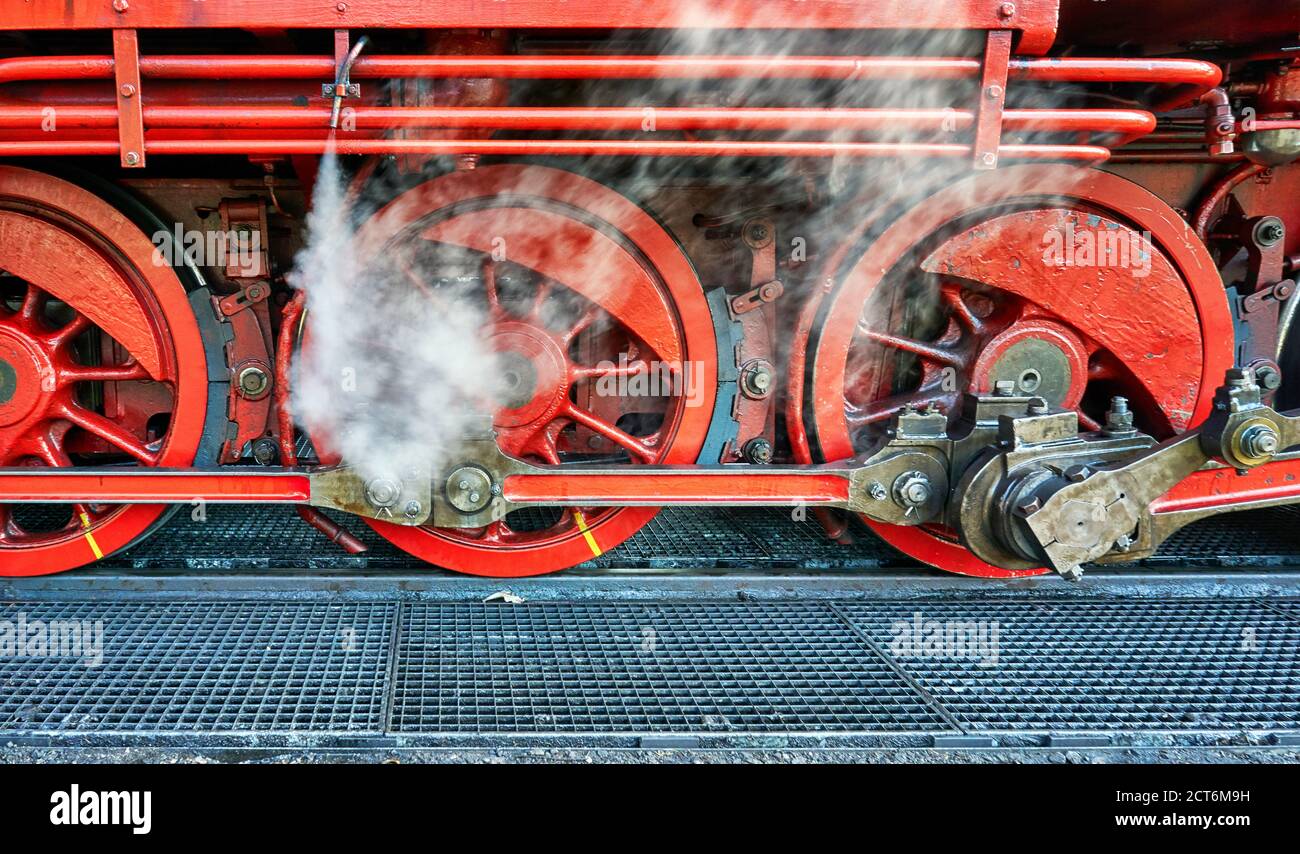 Escaping steam and red wheels of a steam locomotive Stock Photo - Alamy