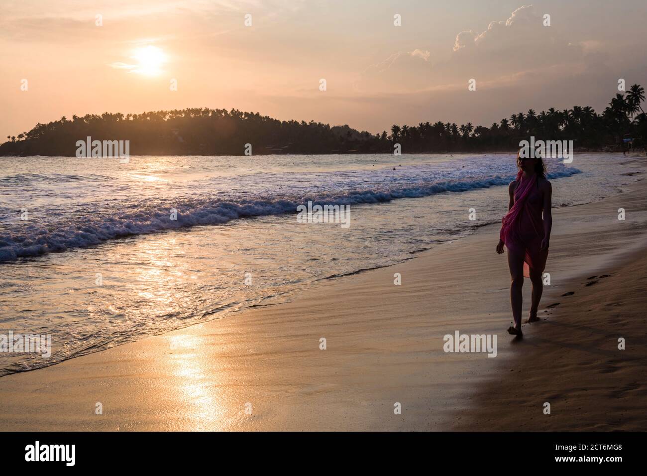 Mirissa, woman on holiday on Mirissa Beach at sunset, South Coast of ...