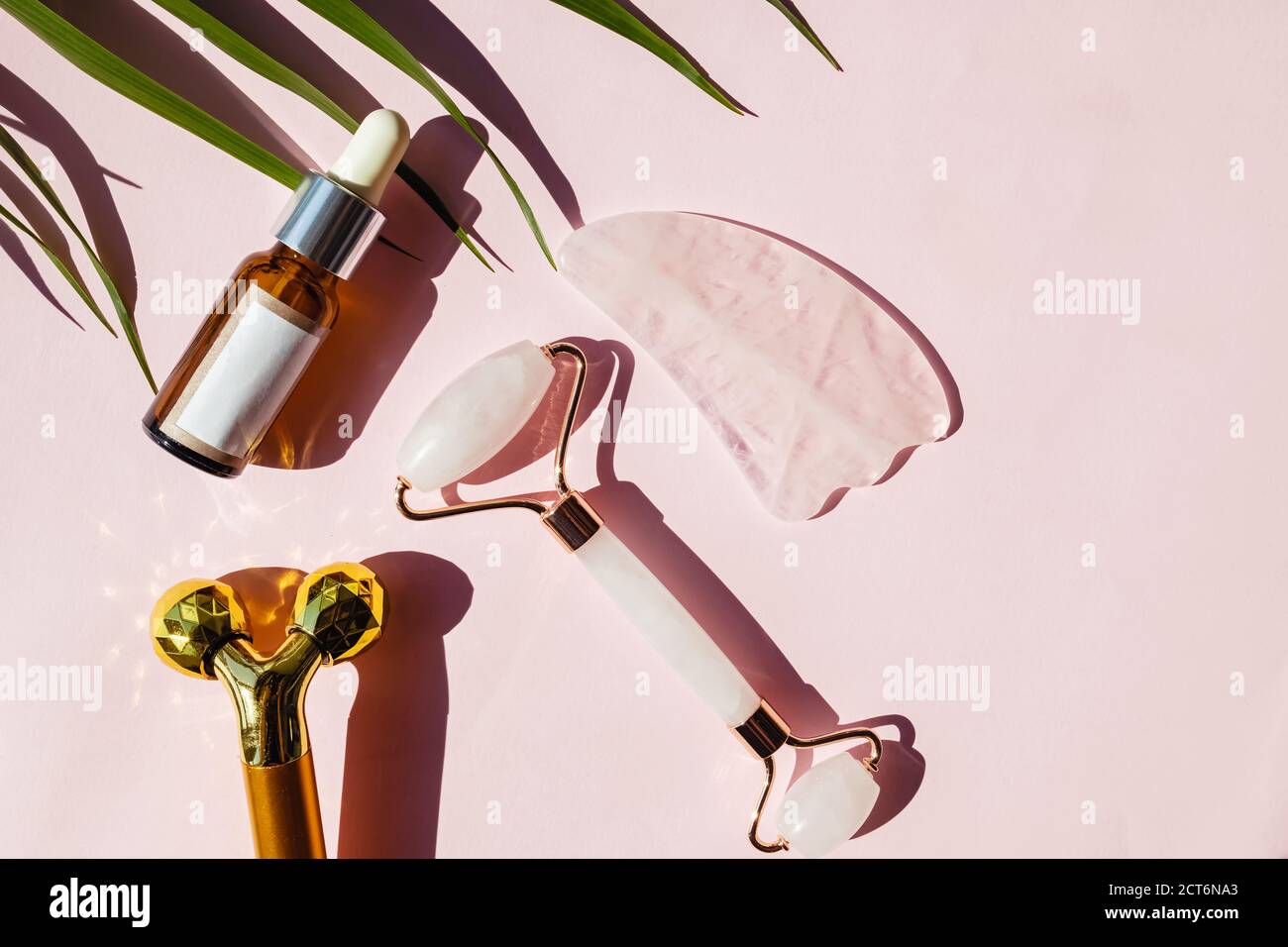 Different tools for face massage and bottle of face care moisturizing ...