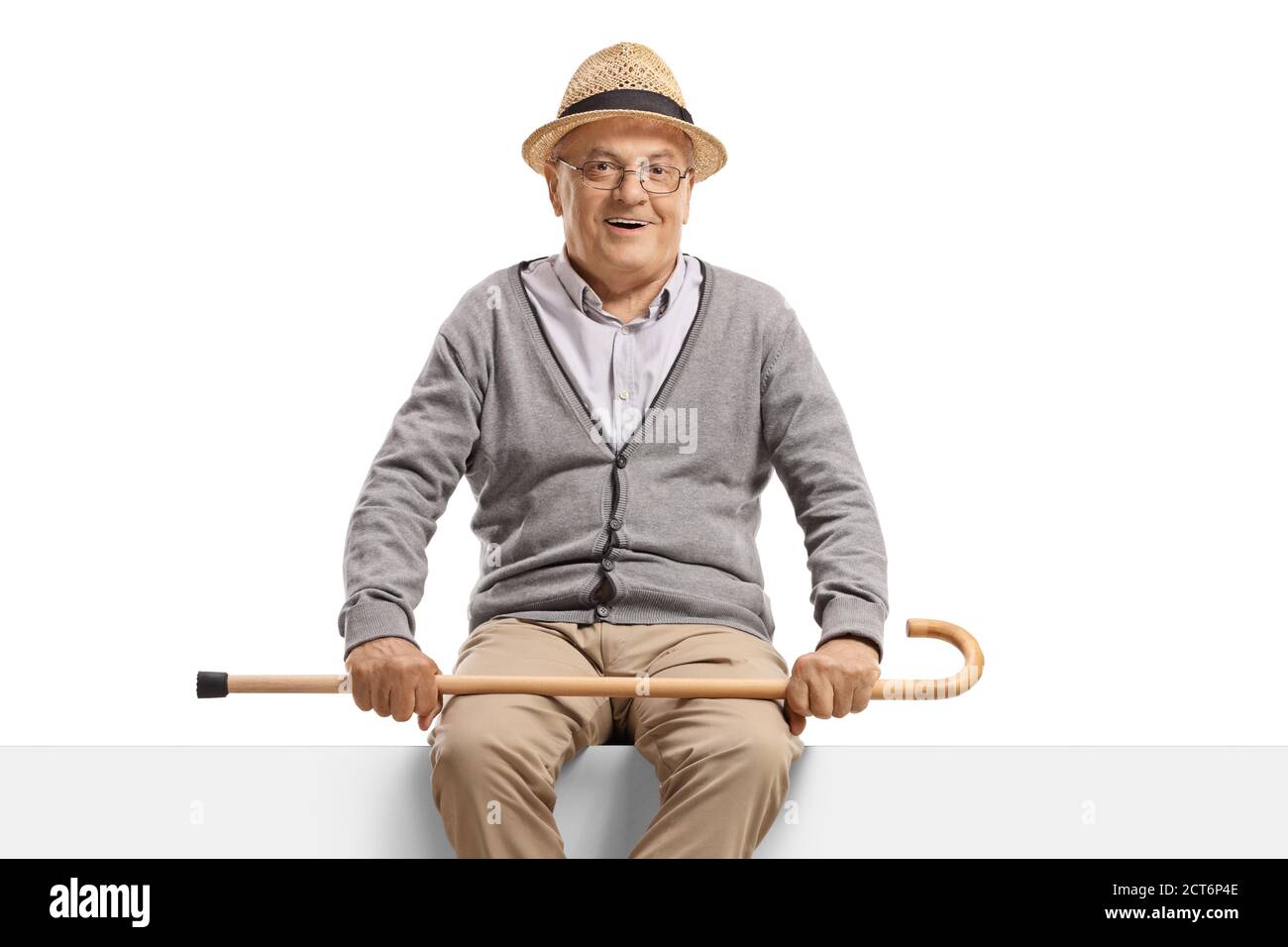 Elderly man sitting on a blank billboard panel and holding a walking ...