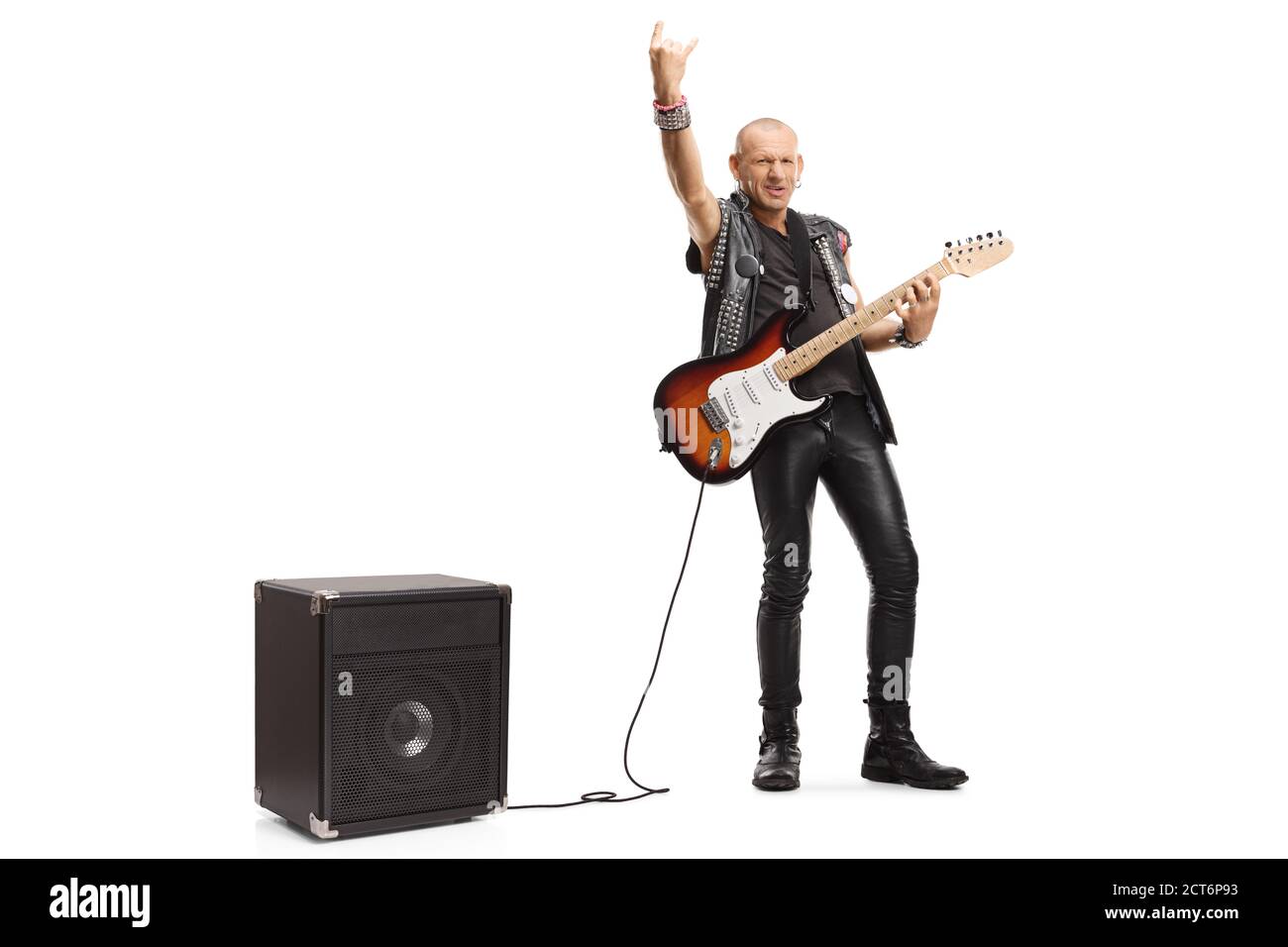 Full length portrait of a rocker with a guitar plugged into an ...