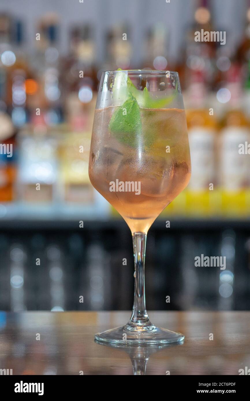 Vertical shot of refreshing alcohol cocktails in a bar table with a ...