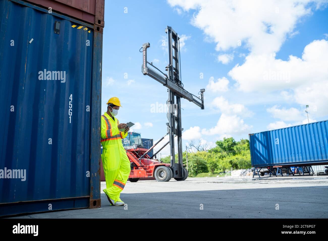 Container worker wearing protective mask to Protect Against Covid-19 ...