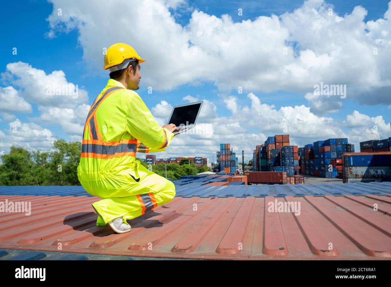 Engineer worker in protective safety jumpsuit uniform use laptop ...