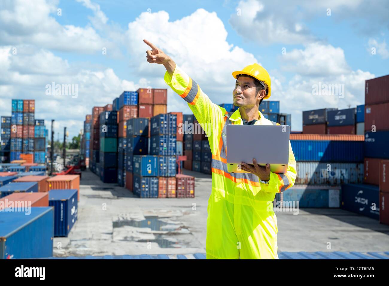 Engineer worker in protective safety jumpsuit uniform use laptop computer checking product at ...