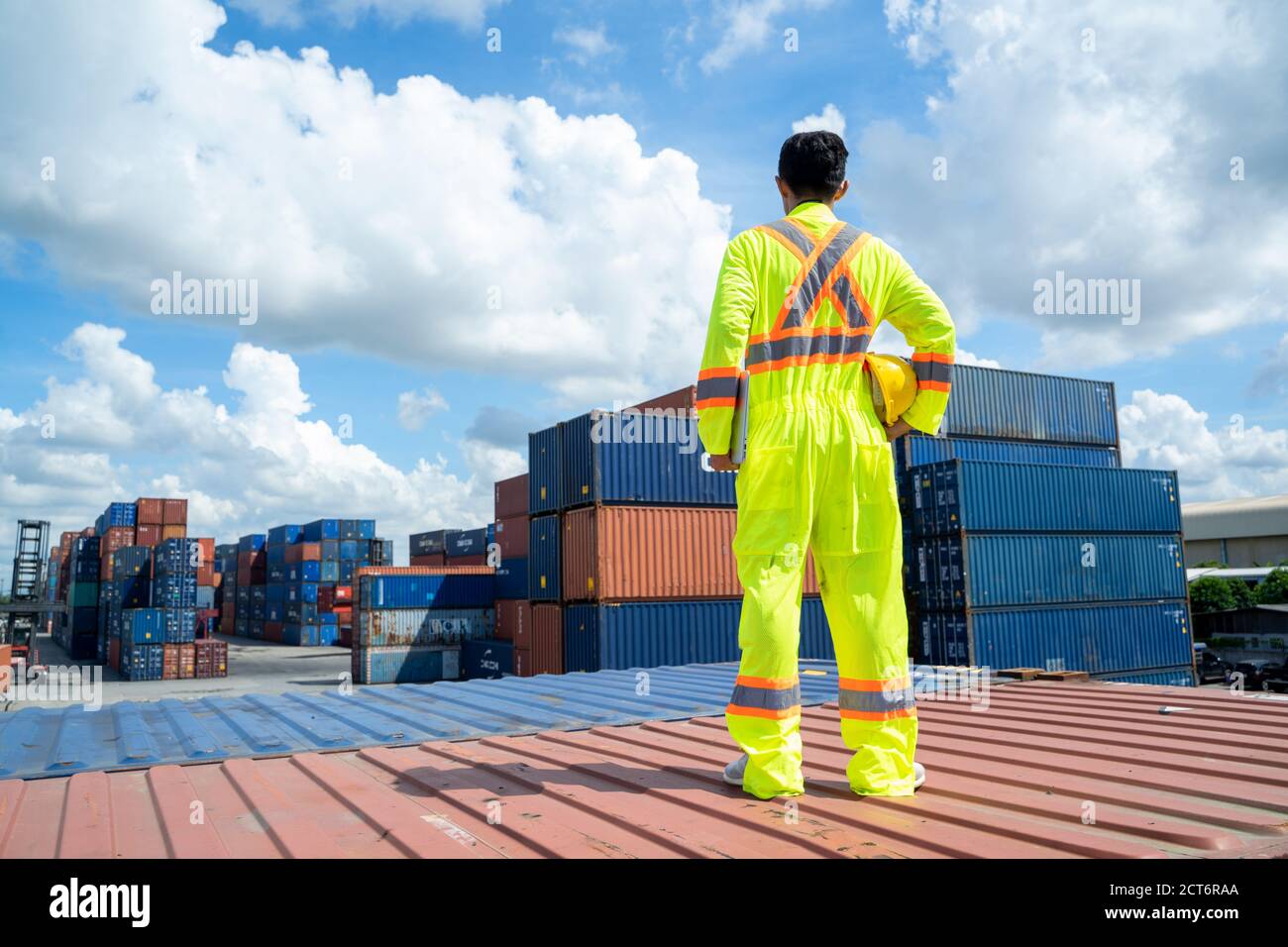 Container worker standing at logistic shipping cargo containers yard ...