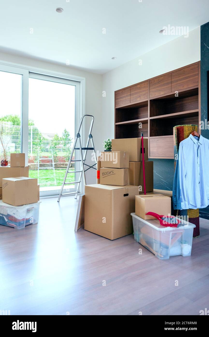 Living room with moving boxes Stock Photo - Alamy