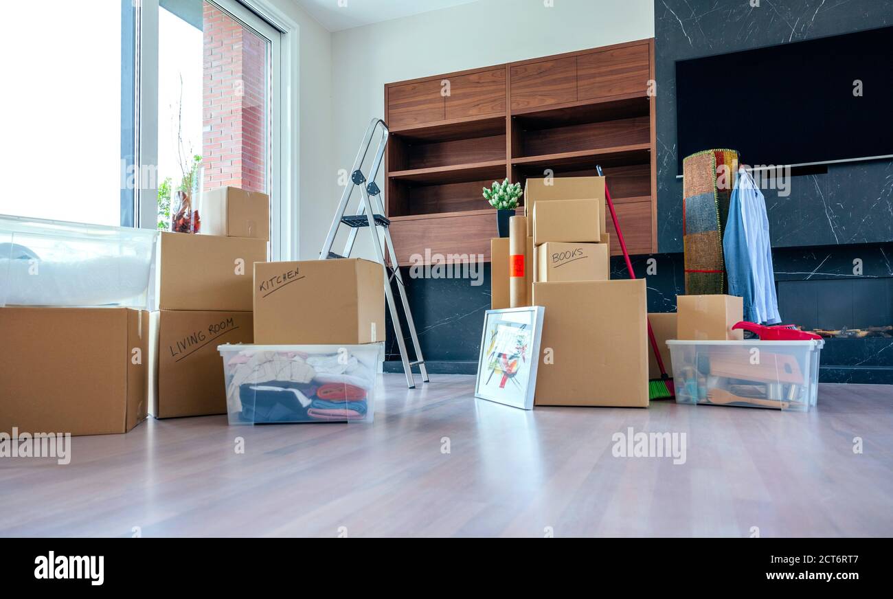Living room with moving boxes Stock Photo - Alamy
