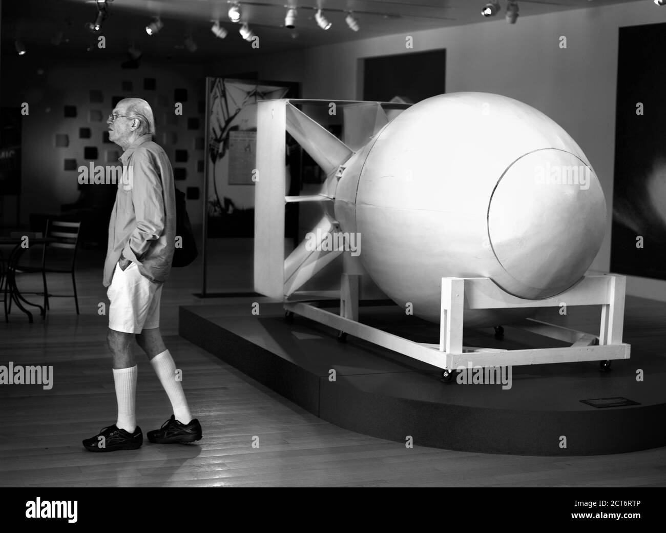 A tourist walks past a lifesize wooden replica of the 'Fat Man' atomic ...