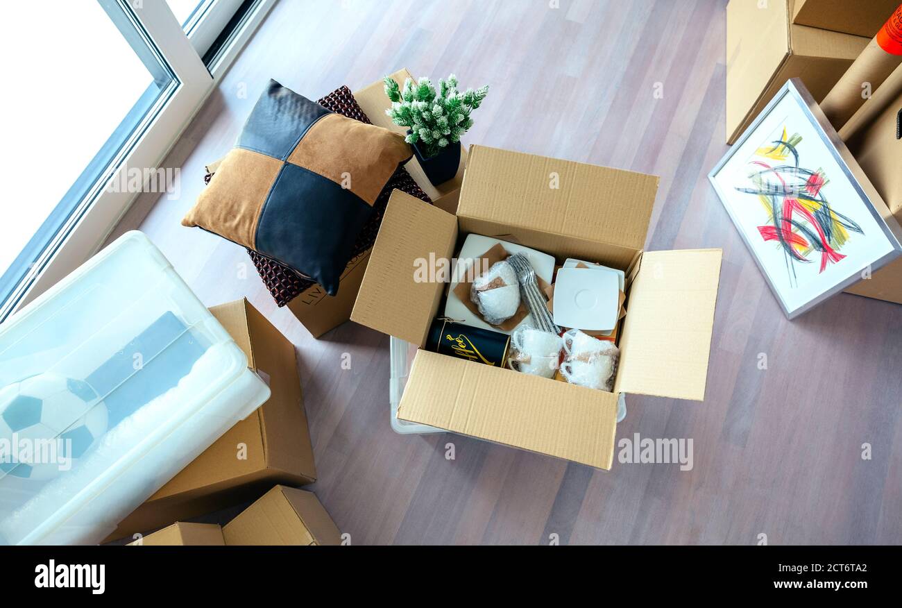 Living room with stack of moving boxes Stock Photo - Alamy