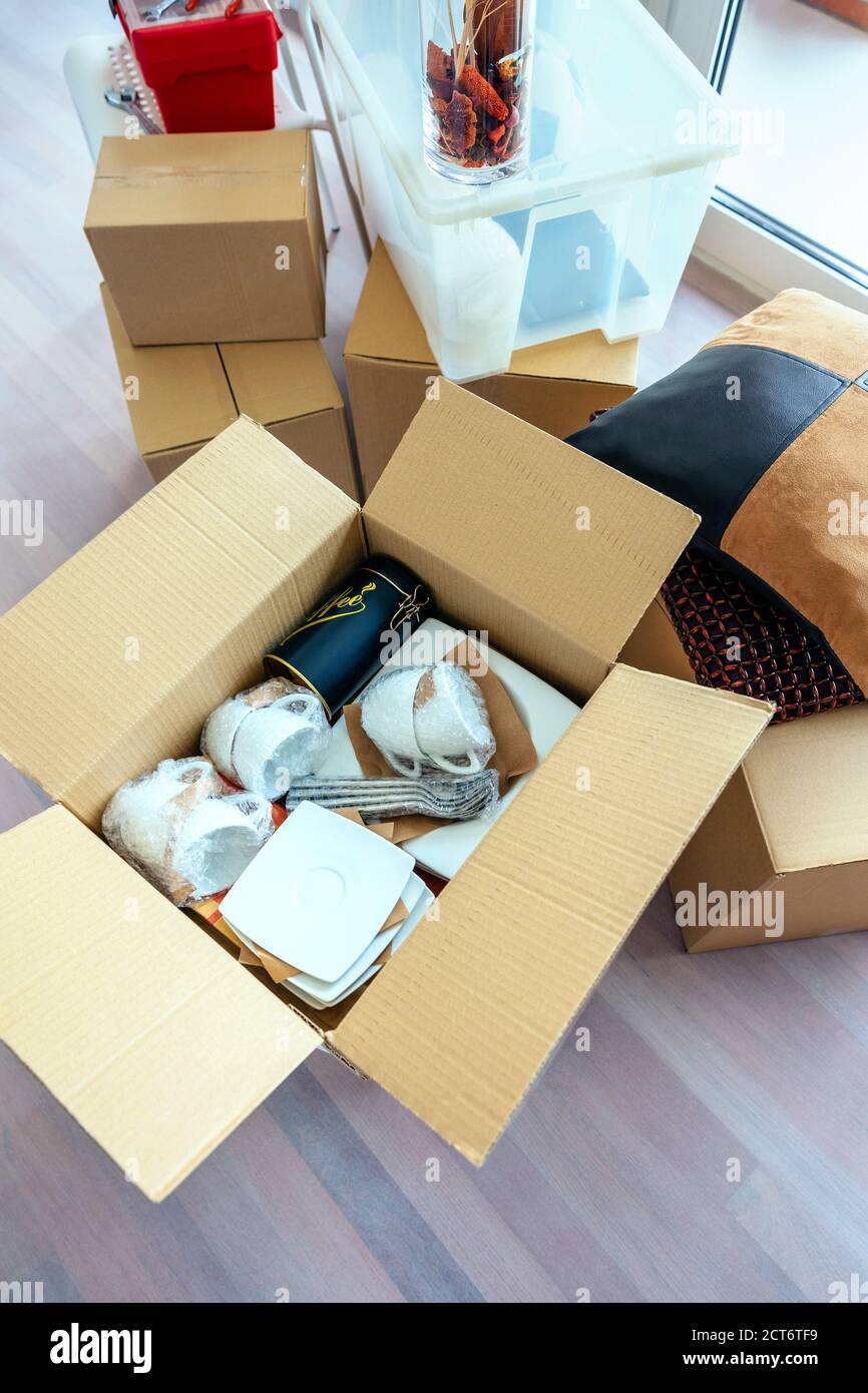 Living room with stack of moving boxes Stock Photo - Alamy
