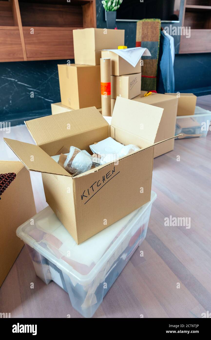 Living room with stack of moving boxes Stock Photo - Alamy