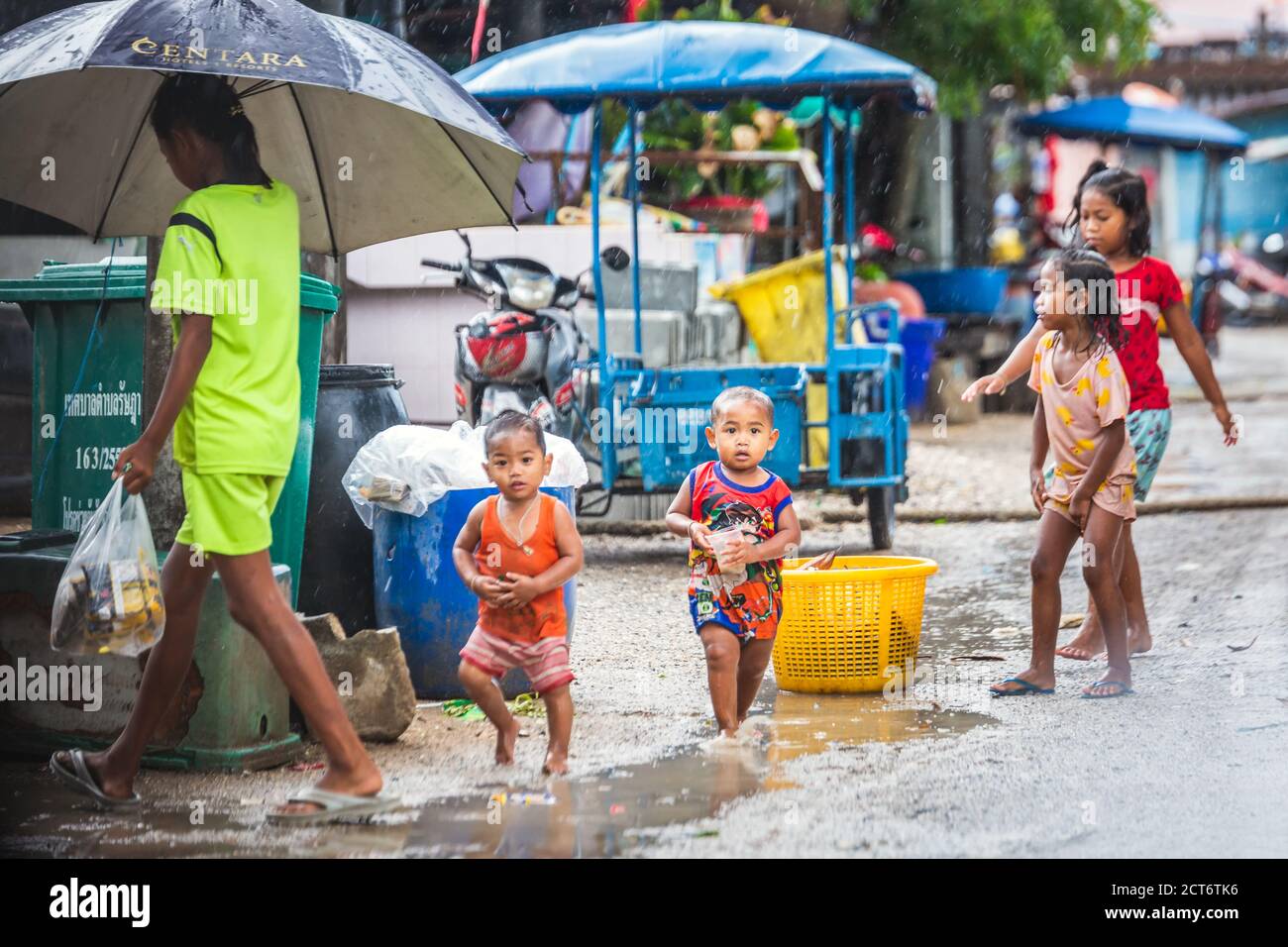 Lifestyle children in Thai countryside. Children playing water splash ...
