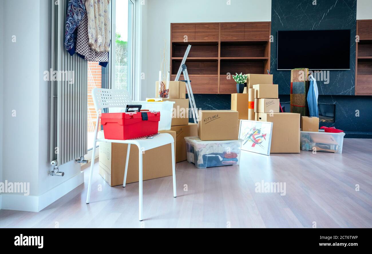 Living room with moving boxes Stock Photo - Alamy