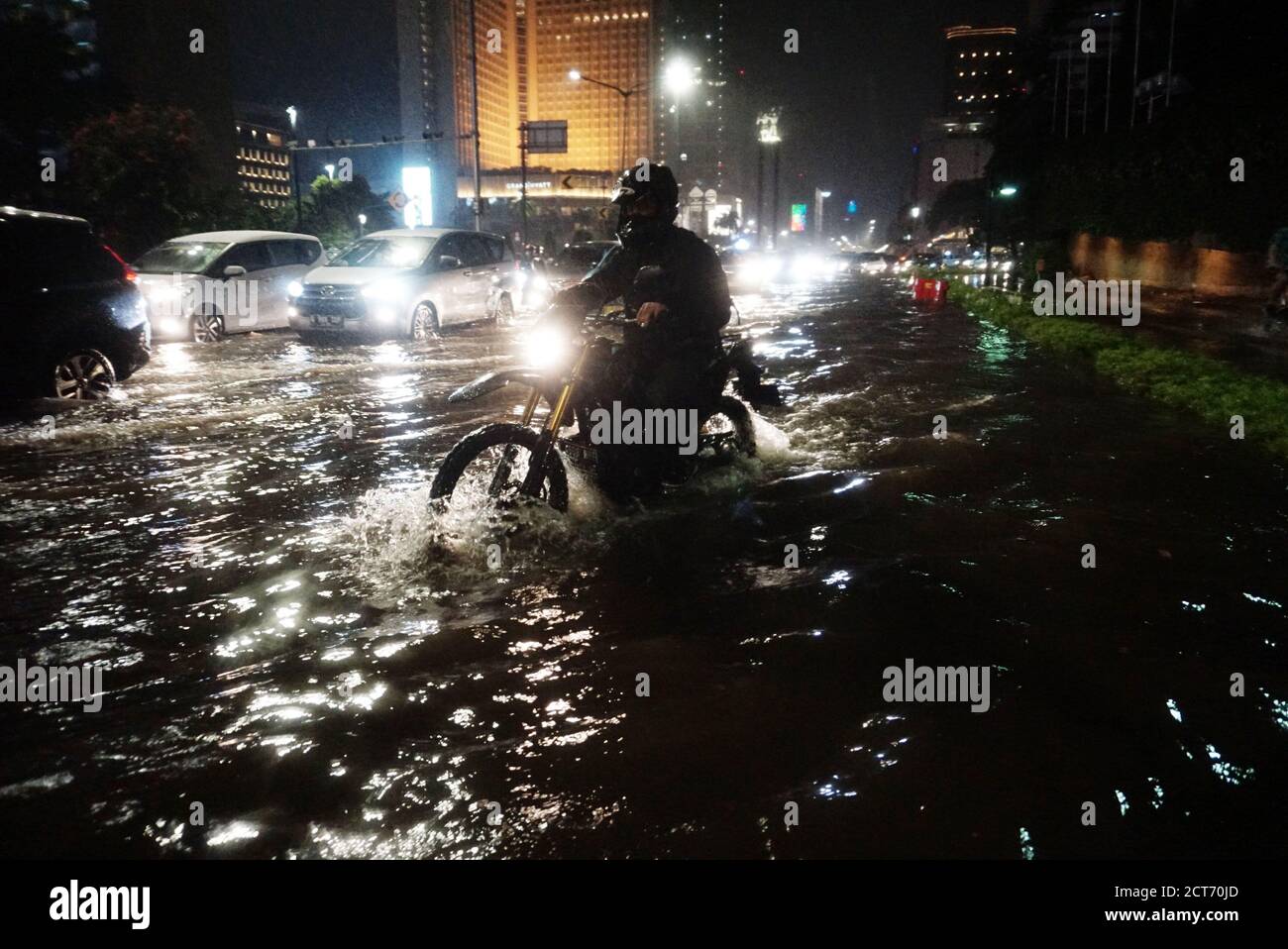 Jakarta, Indonesia. 21st Sep, 2020. Vehicles run through a flooded ...