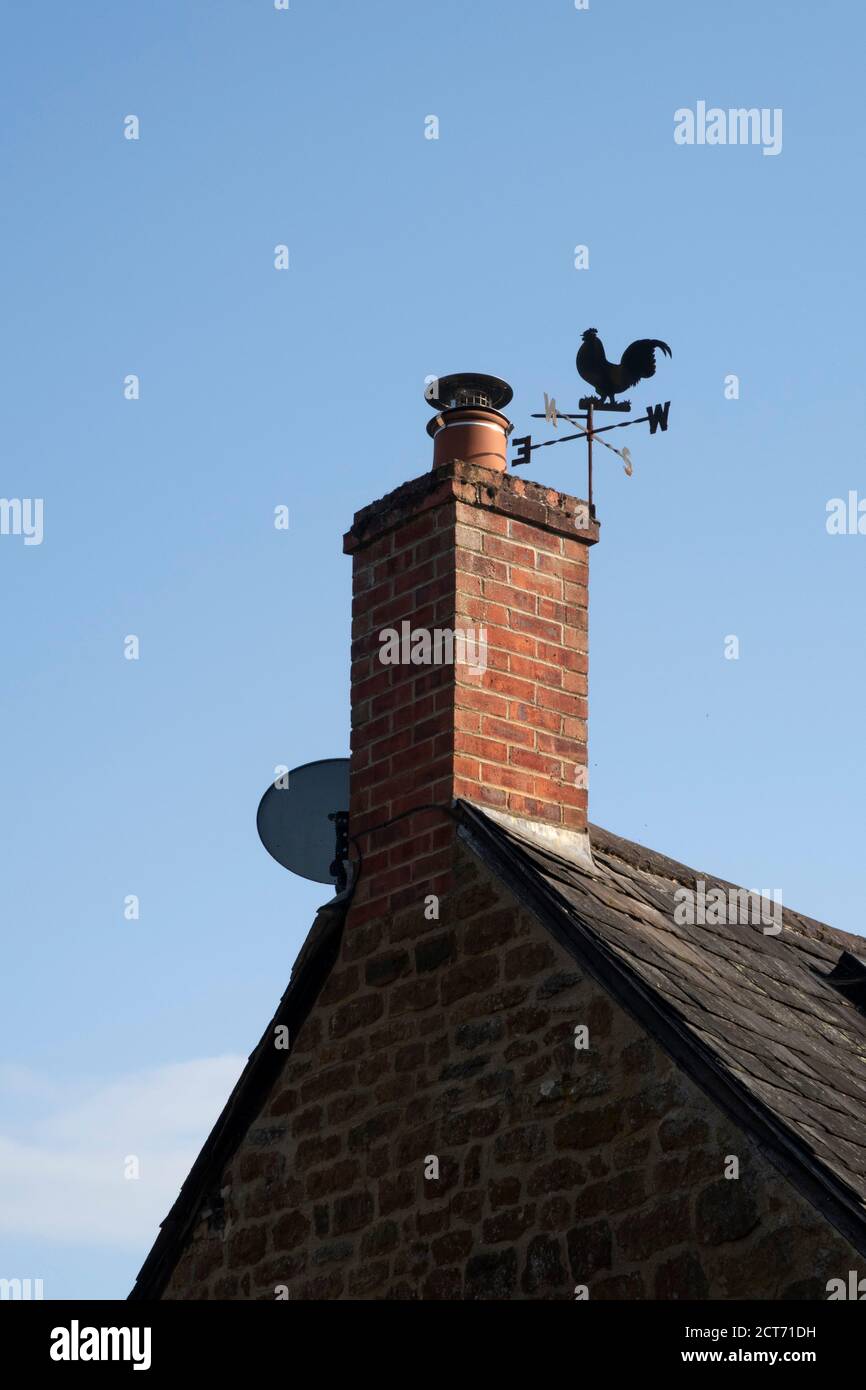 Weather vane on chimney on a house in the north Oxfordshire village of ...