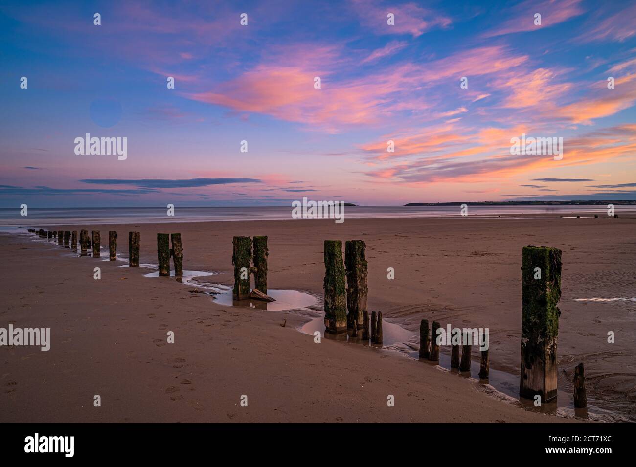 Summer Evening on Youghal strand with the last of sun catching the ...