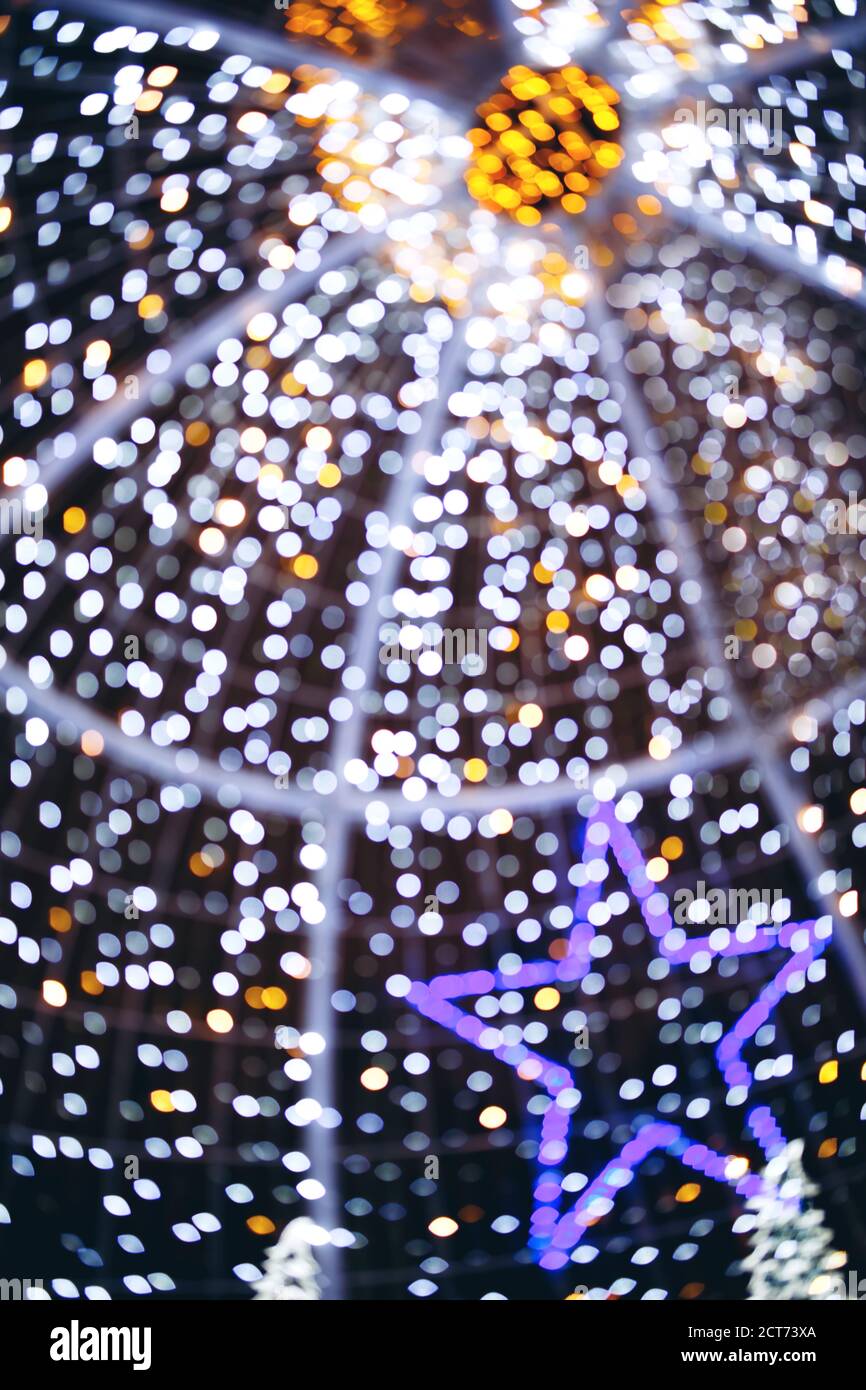 Abstract night holiday background with defocused Christmas illumination ...