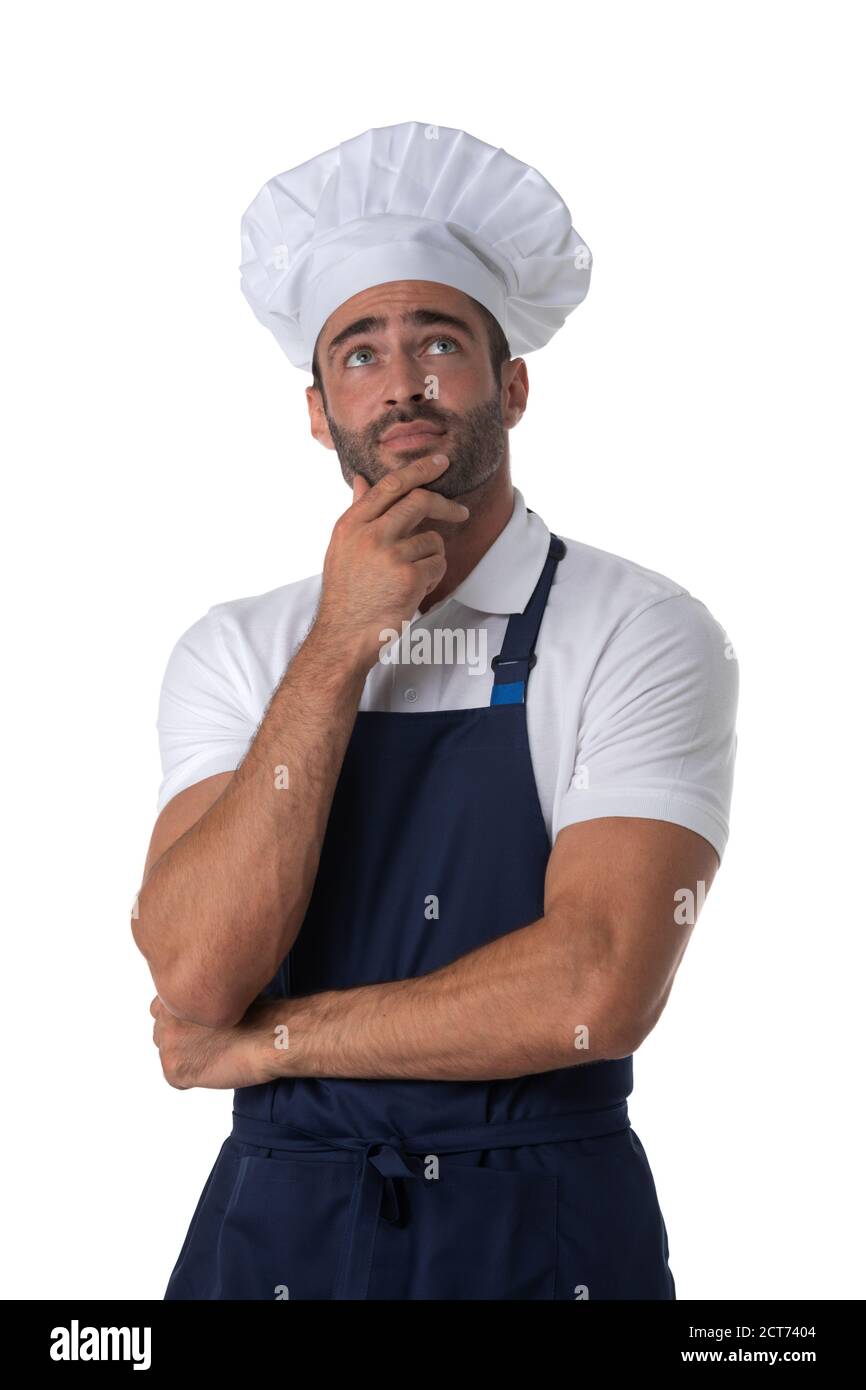 Portrait of male cook in apron and hat thinking holding hand on chin ...