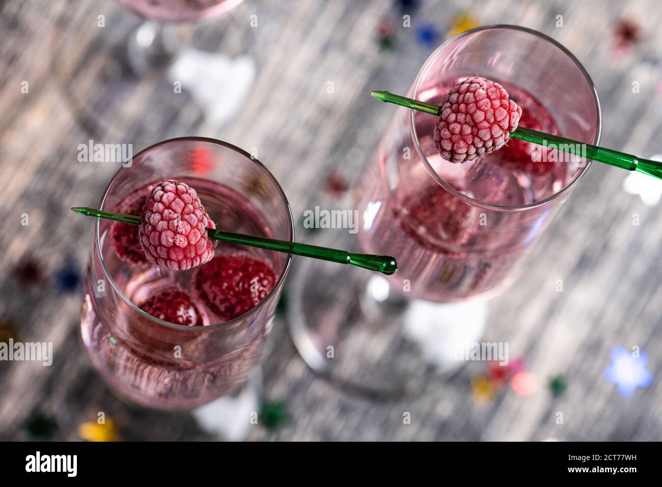 Pink sparkling cocktail with a raspberry Stock Photo - Alamy
