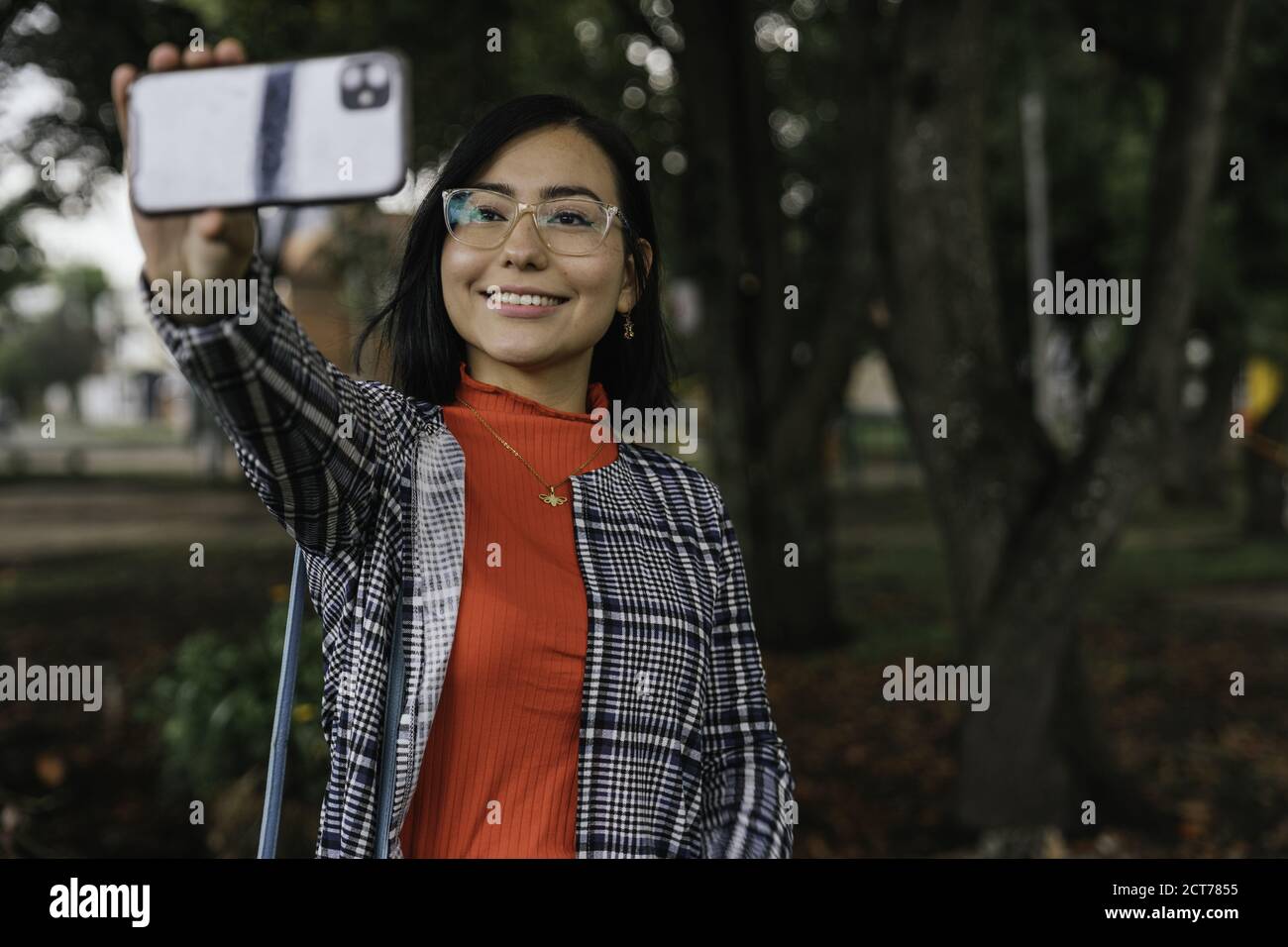Smiling woman taking mobile selfie hi-res stock photography and images ...