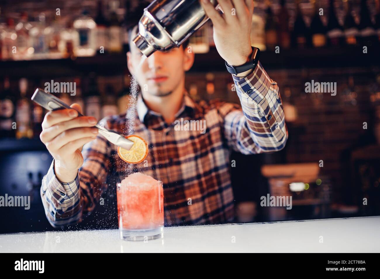 Barman mixes red cocktail show with colorful alcoholic bar counter ...