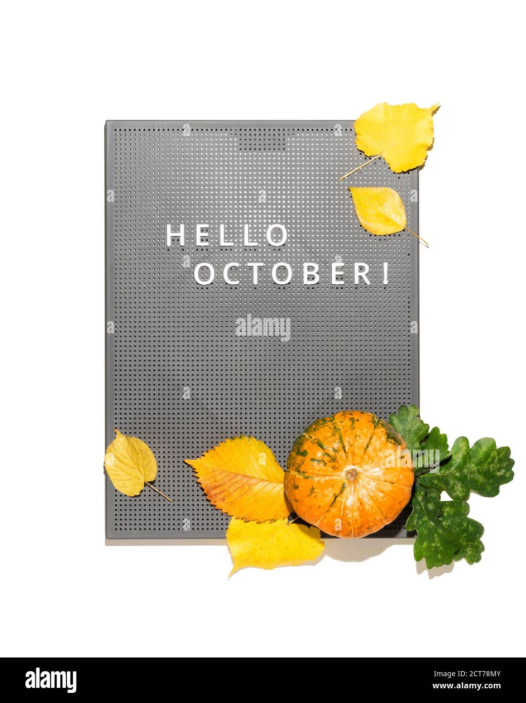 Hello october text on grey letter board and yellow and green fall ...